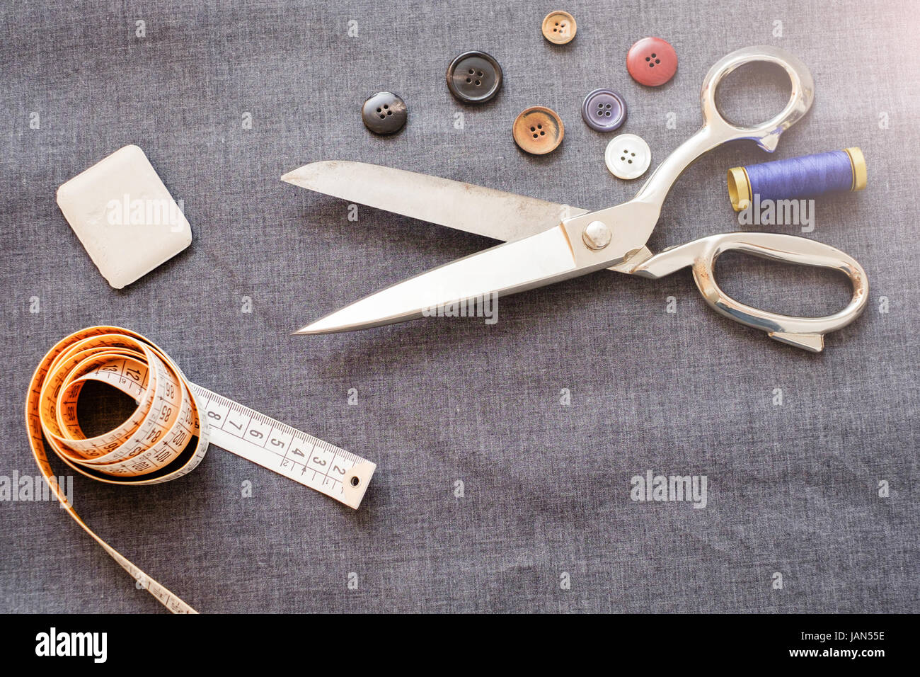 Tailor tools isolated on piece of fabric background Stock Photo - Alamy