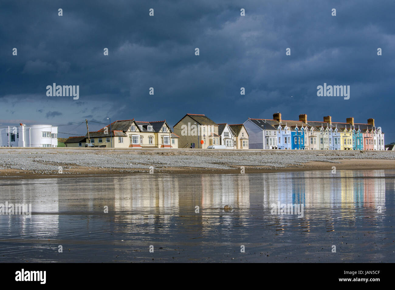 Houses reflected on the wet sand of Borth Beach on the West Coast of ...