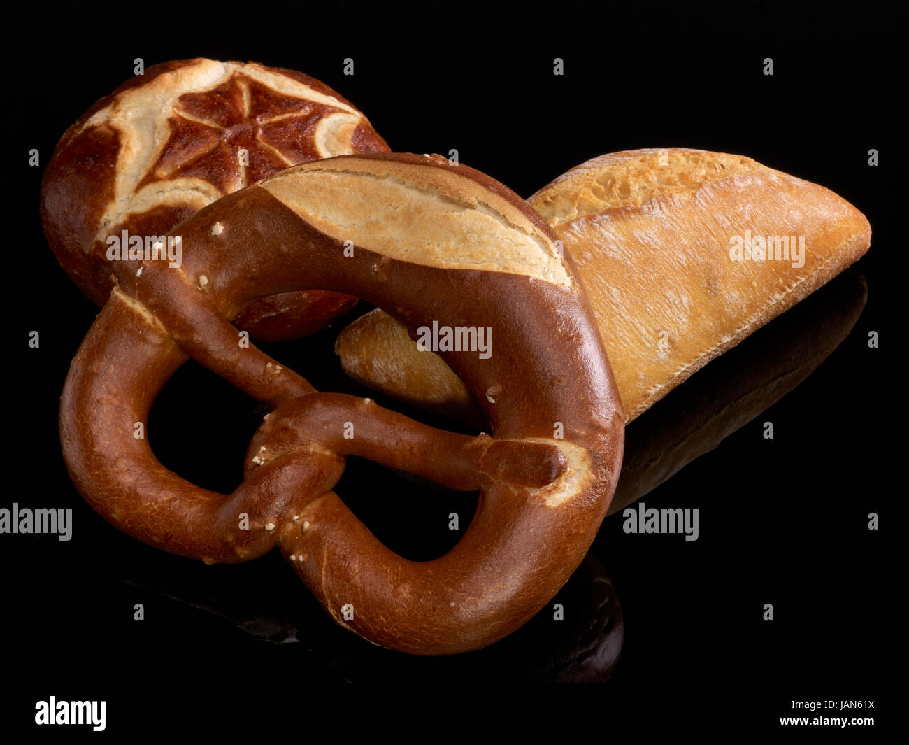german lye rolls and bread roll in black reflective back Stock Photo ...