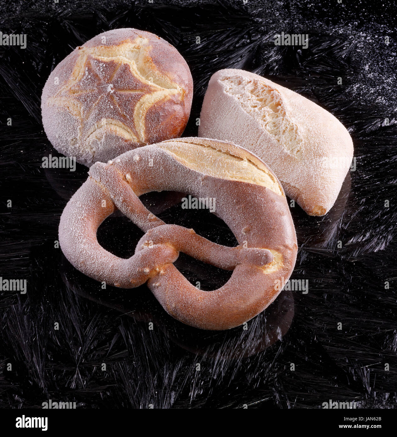 frozen german lye rolls in black background covered with frost pattern ...