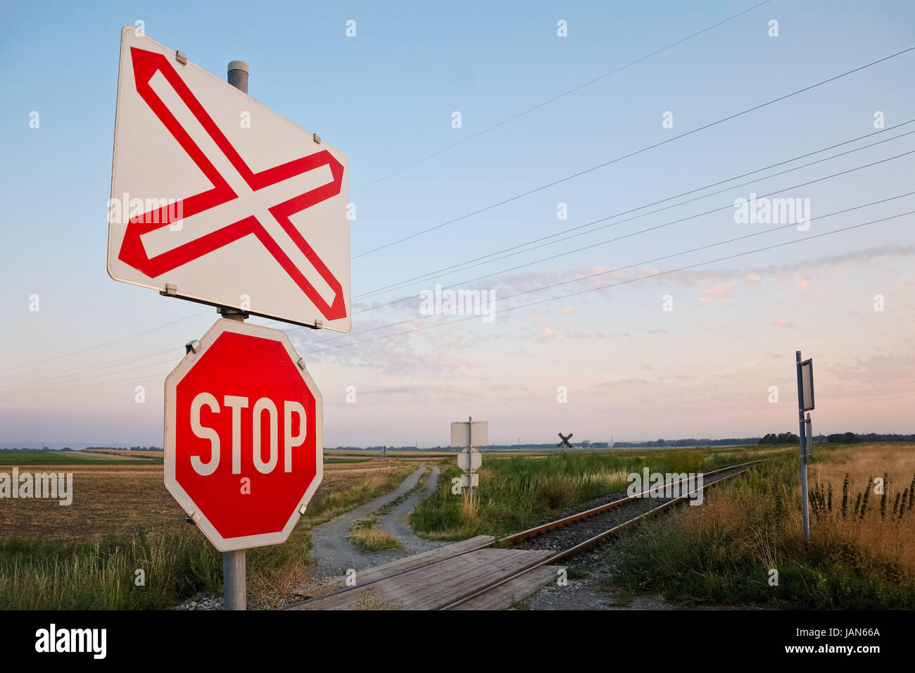 railroad crossing with stop board Stock Photo - Alamy
