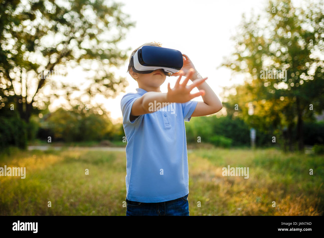 Fascinated little boy using VR virtual reality goggles Stock Photo - Alamy