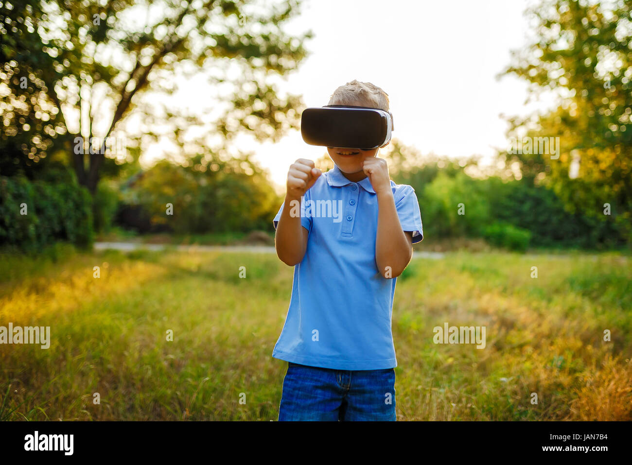 Fascinated little boy using VR virtual reality goggles Stock Photo - Alamy