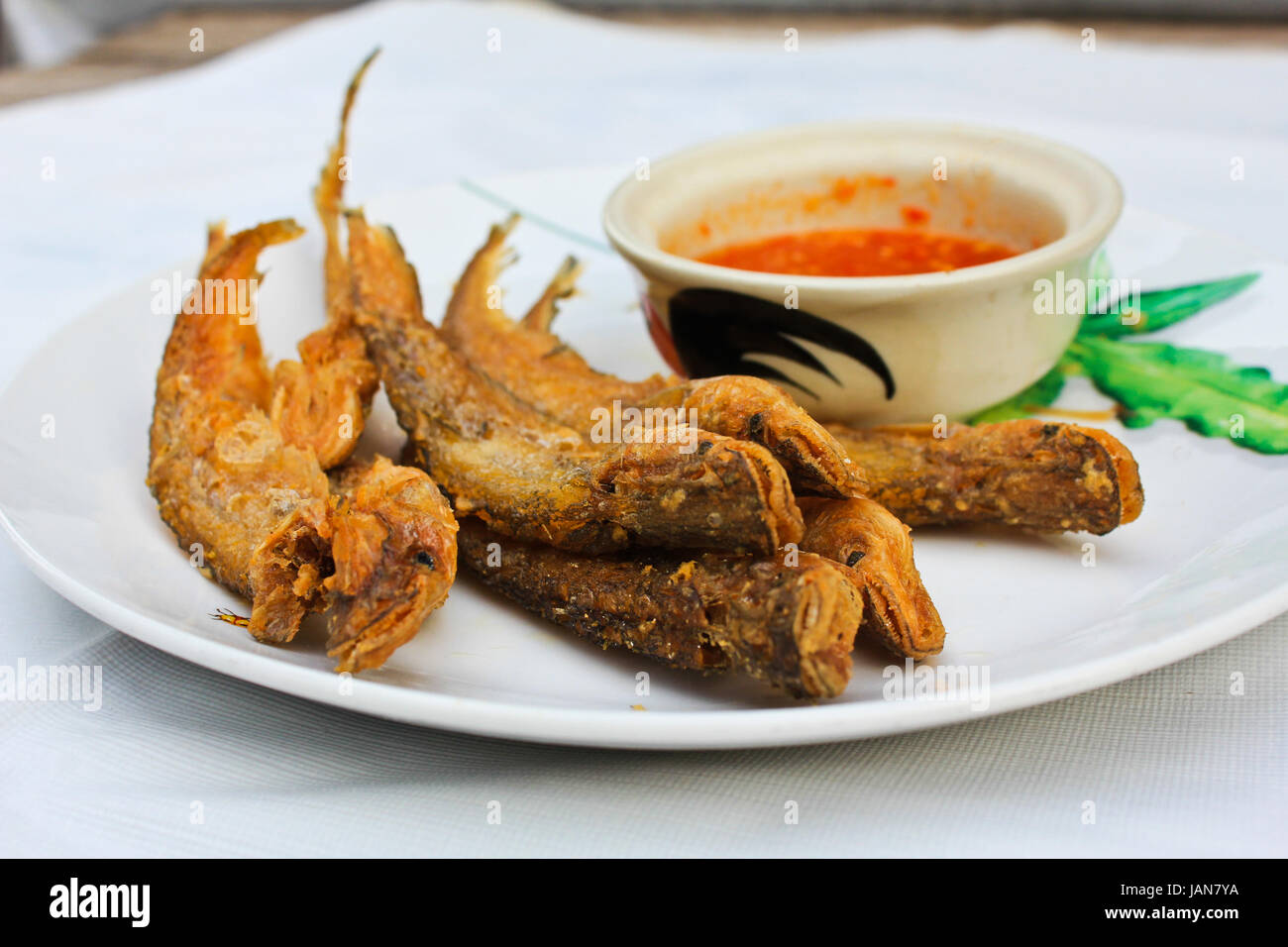 Fried small fish on the plate Stock Photo - Alamy