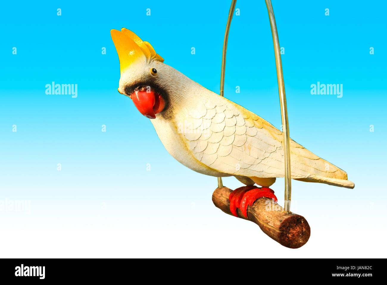 Colorful wooden statuette of a parrot isolated Stock Photo - Alamy
