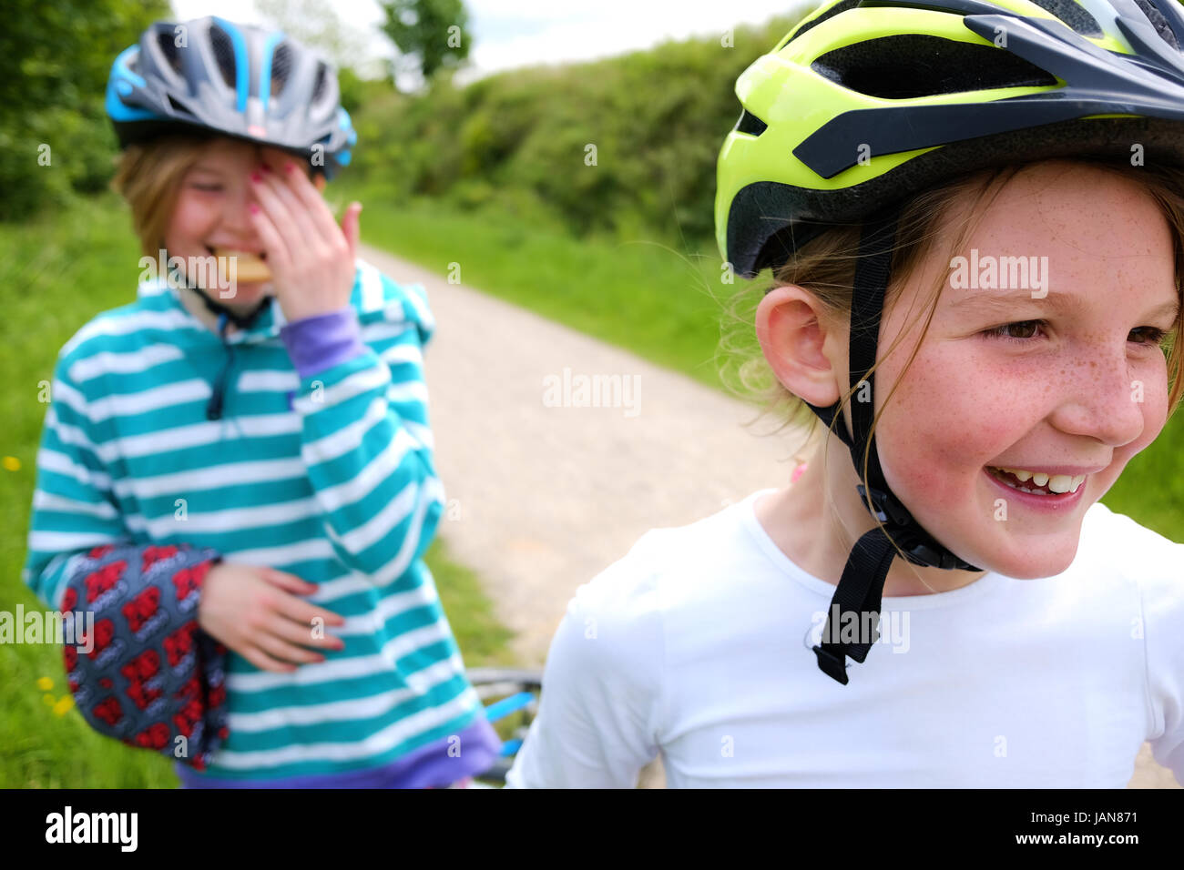 Two girls cycling on the Tissington and High Peak trail in the Peak ...