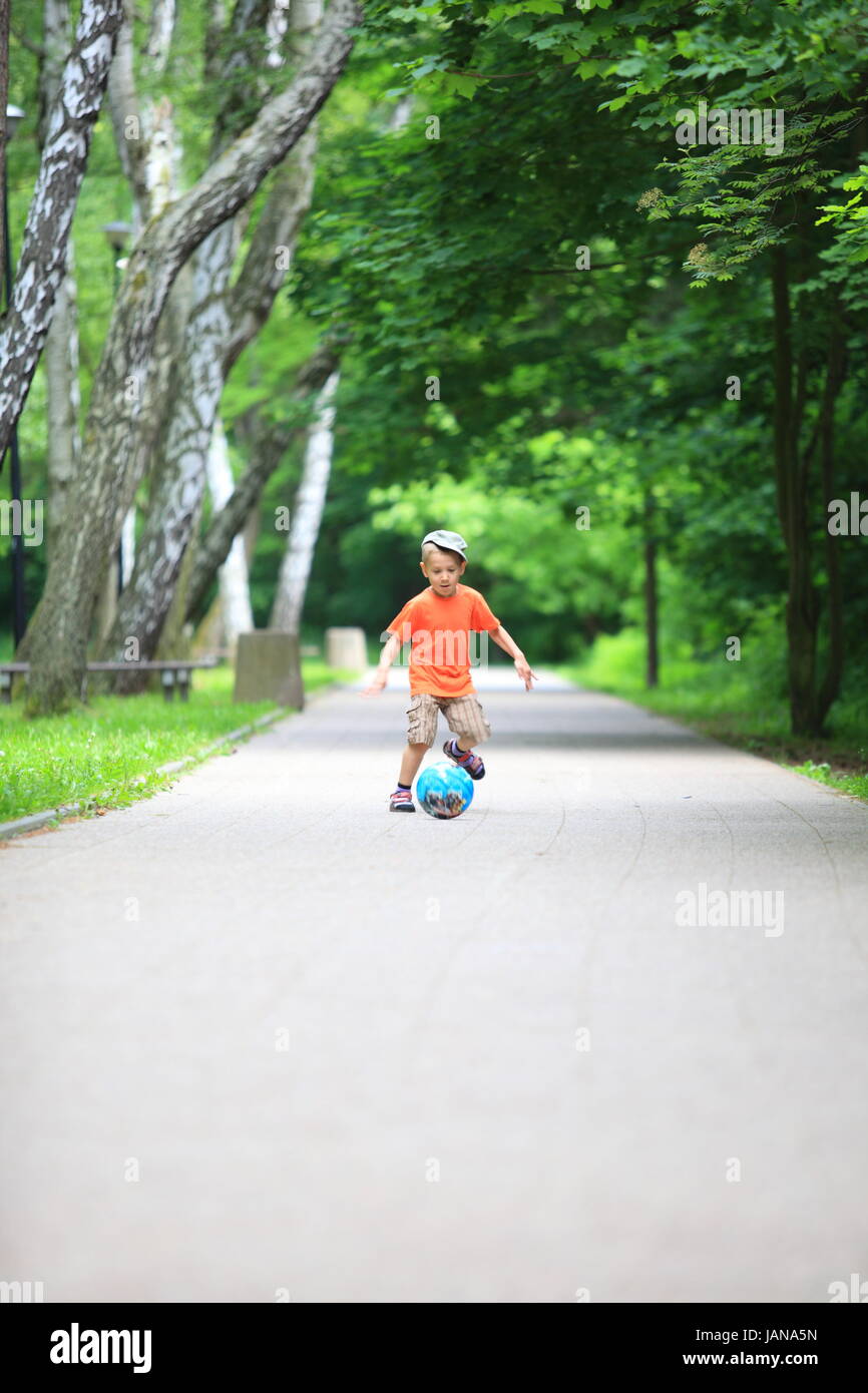 Child running ball road hi-res stock photography and images - Alamy