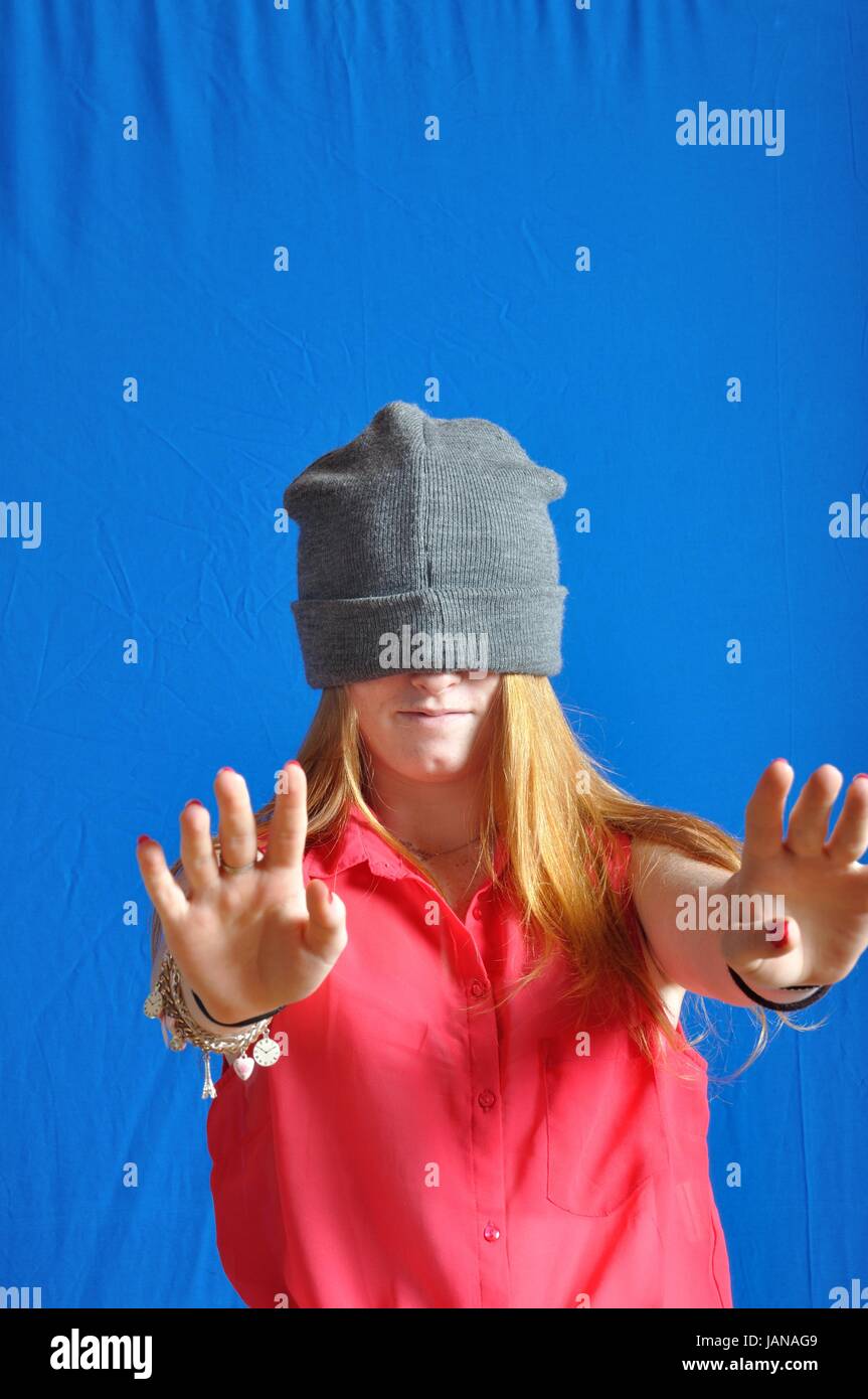 Teen hiding his face with his bonnet Stock Photo - Alamy