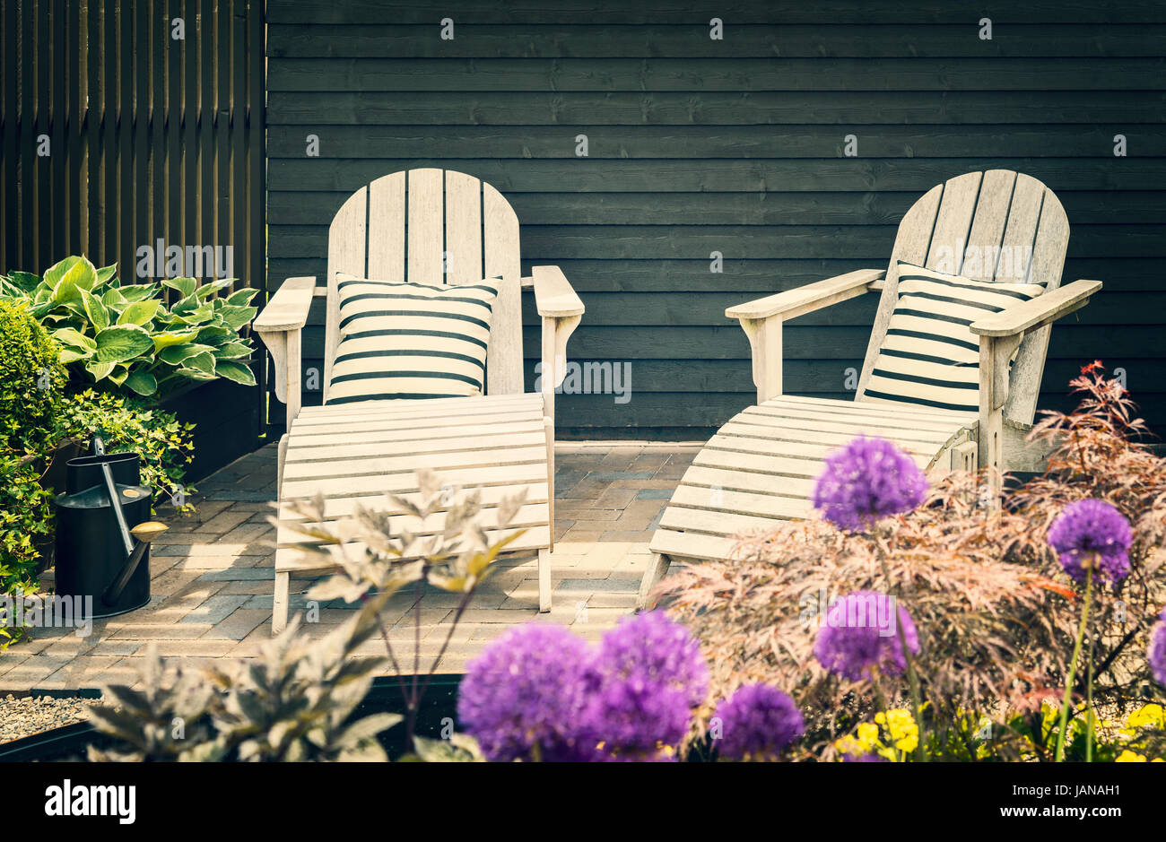 Cozy lounge furniture on landscaped garden terrace Stock Photo - Alamy