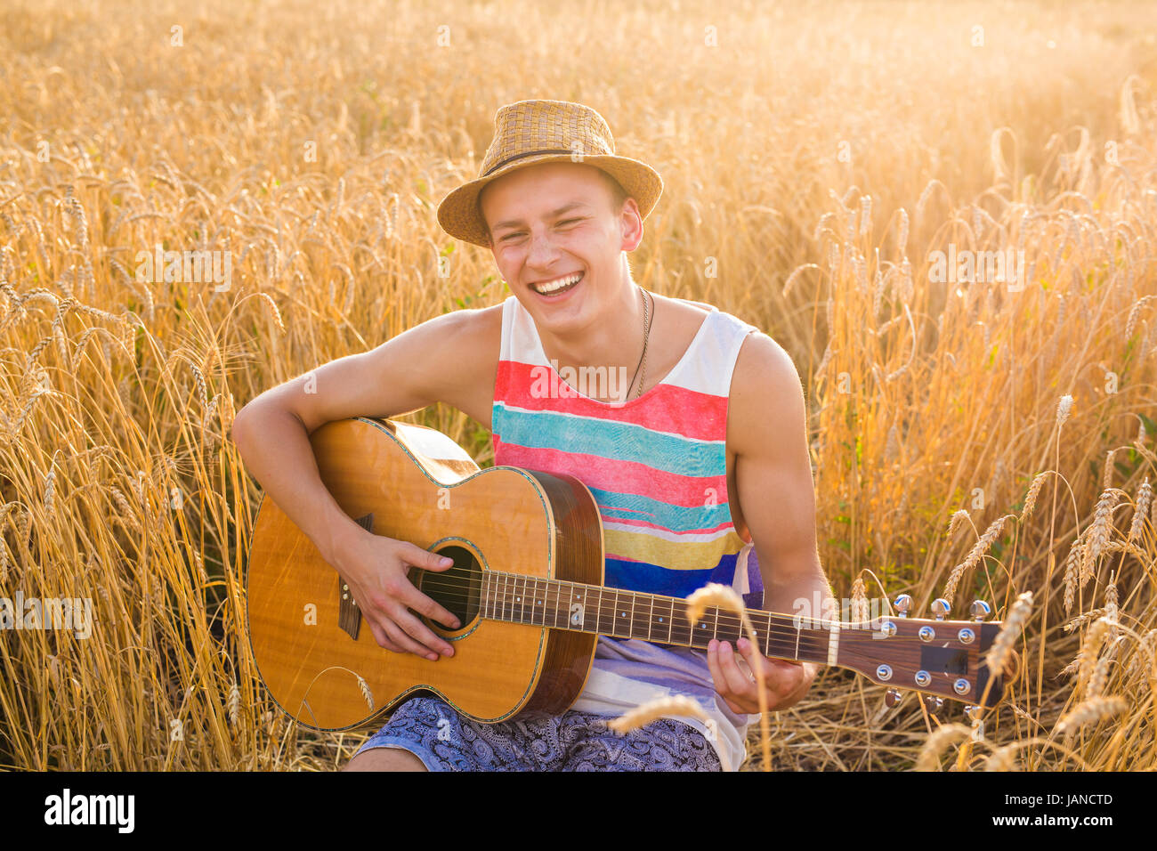 man outdoors playing acoustic guitar Stock Photo - Alamy