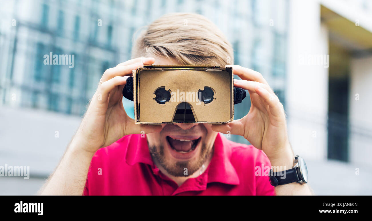 Funny man using cardboard virtual reality goggle outdoors Stock Photo ...