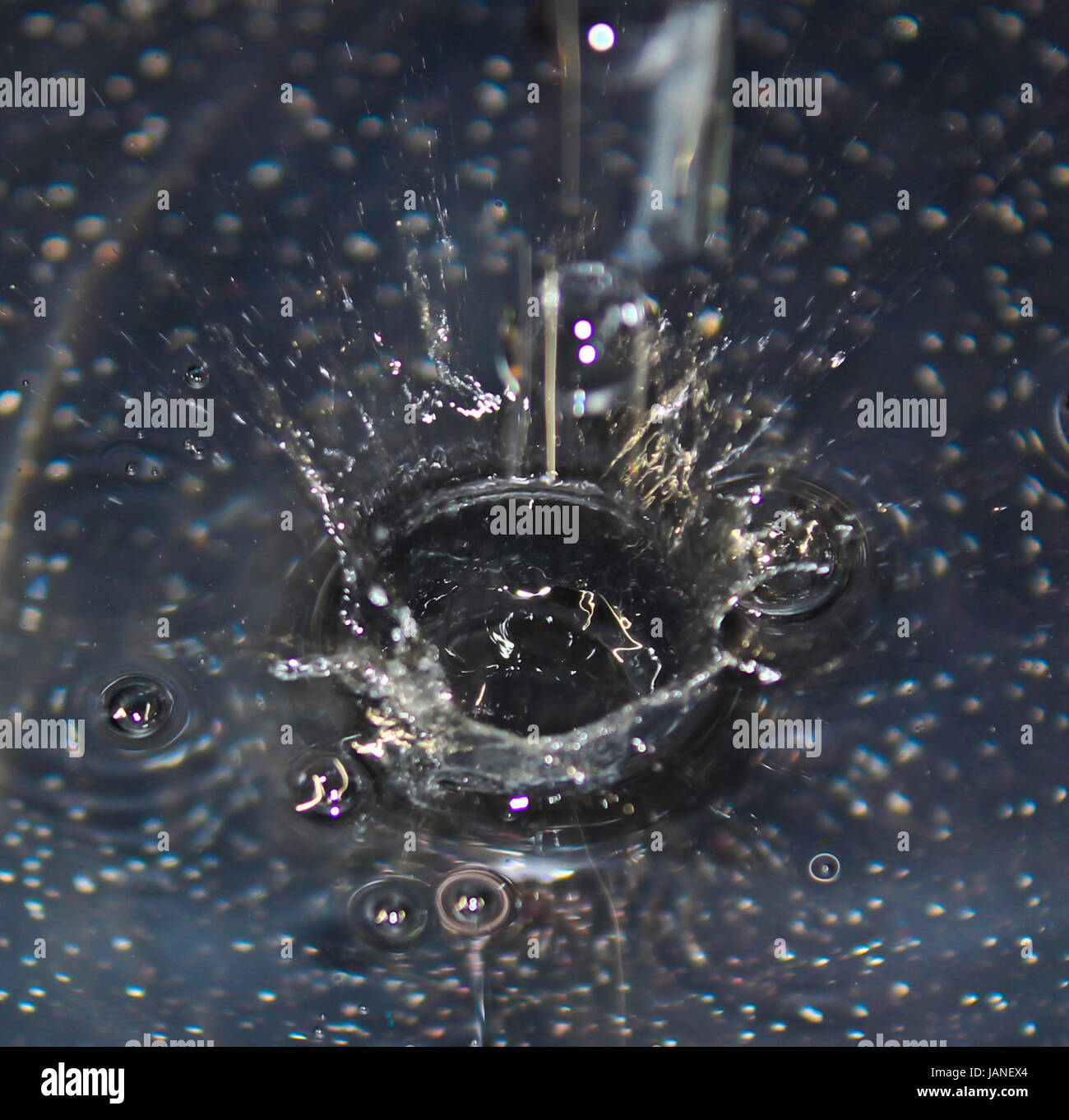Water drip splash on a surface of water Stock Photo - Alamy