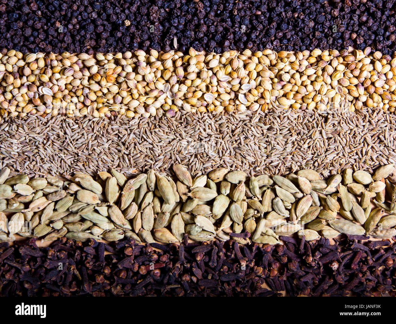 Row of dry spices background Stock Photo - Alamy