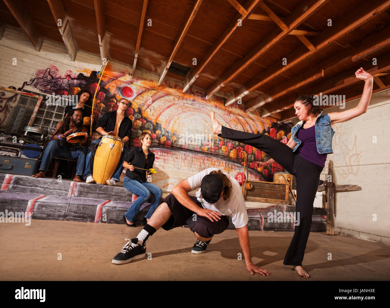 Man dodging a woman kicking during a capoeira performance Stock Photo ...