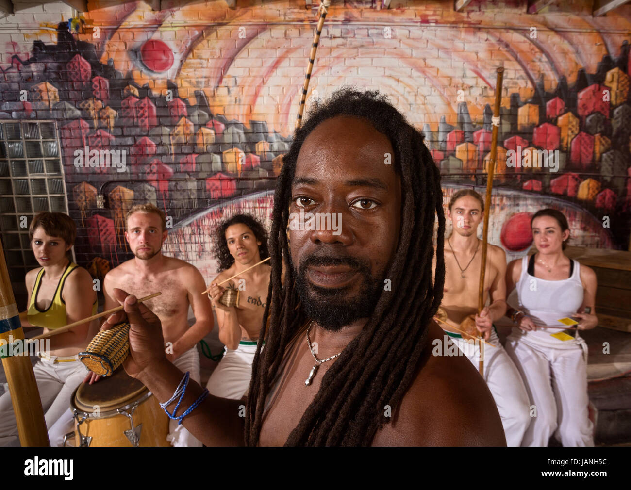 Handsome African capoeira master with students playing music Stock ...