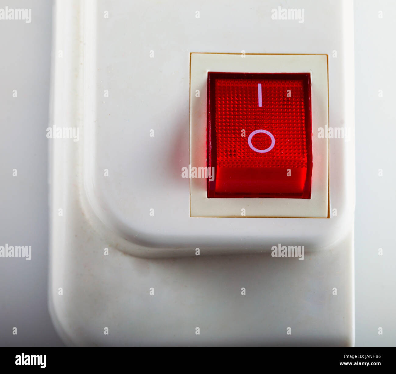 Red switch over a white electric connector Stock Photo - Alamy