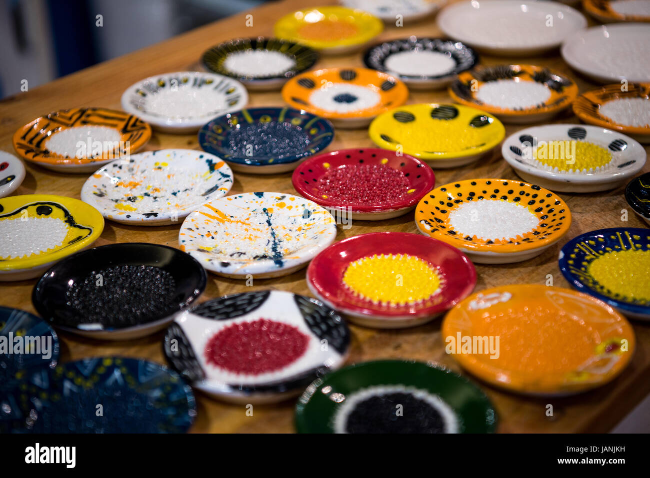 Little colorful plates with a rough centre on a wooden table Stock ...