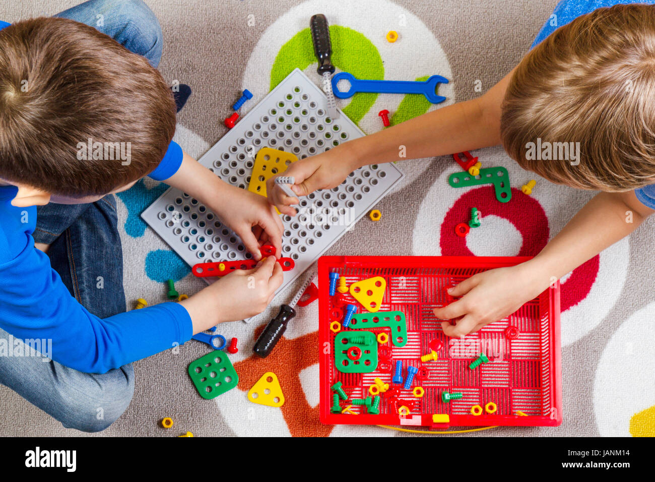 Kids playing with toys tool kit.Top view Stock Photo - Alamy