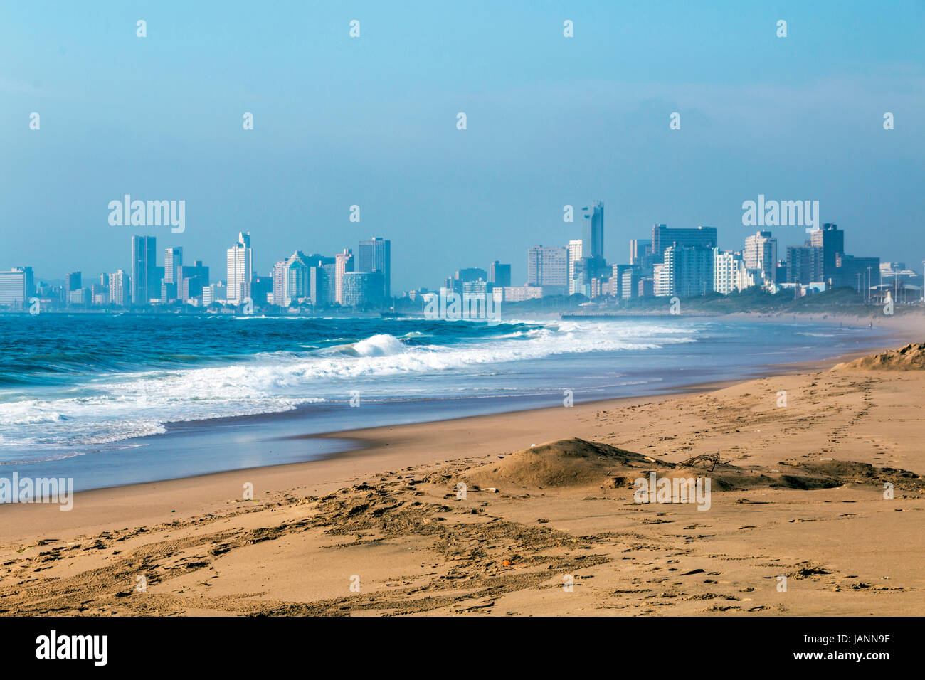 Sand beach and shoreline against "Golden Mile" coastal city skyline in Durban, South Africa ...