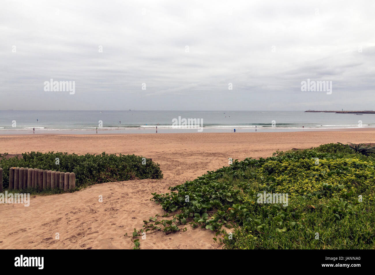 Sand pathway between dune vegetation entrance onto beach against ...