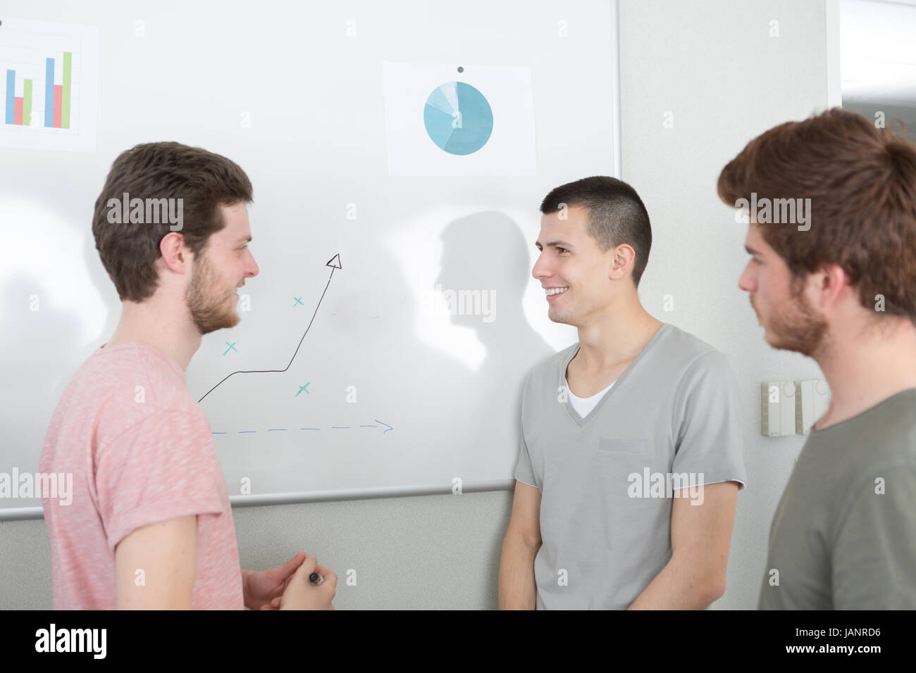 student drawing a diagram on a flip chart board Stock Photo - Alamy