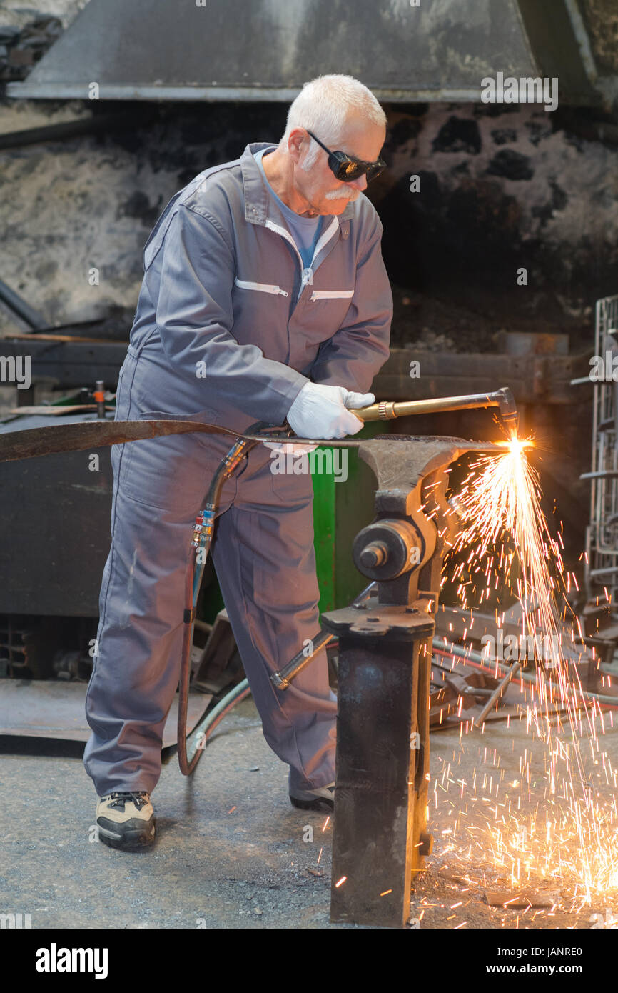 old worker repairing old transformer and welding copper wire Stock ...