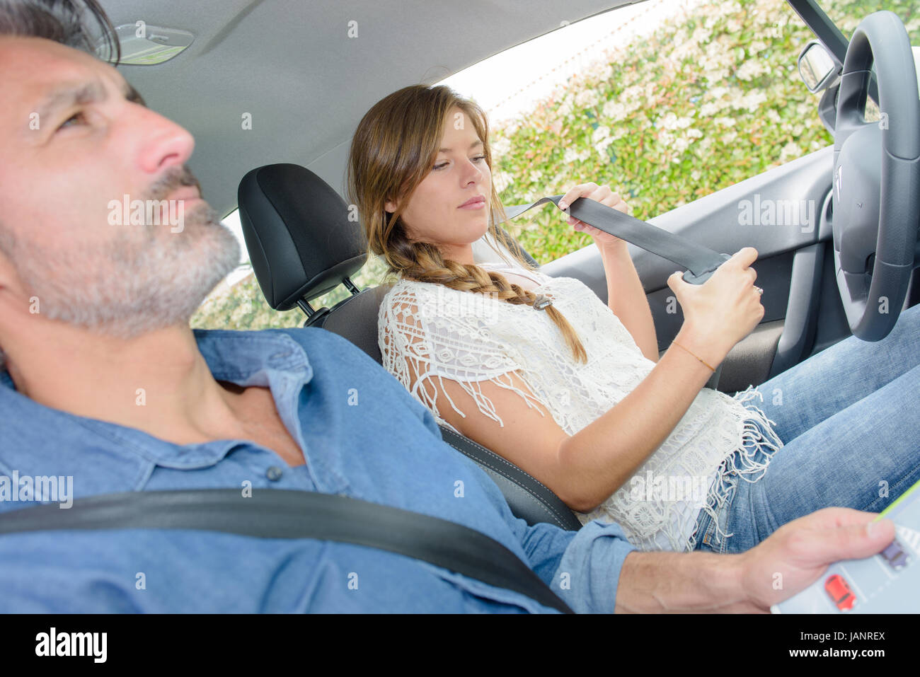 driving instructor and woman student in examination car Stock Photo - Alamy