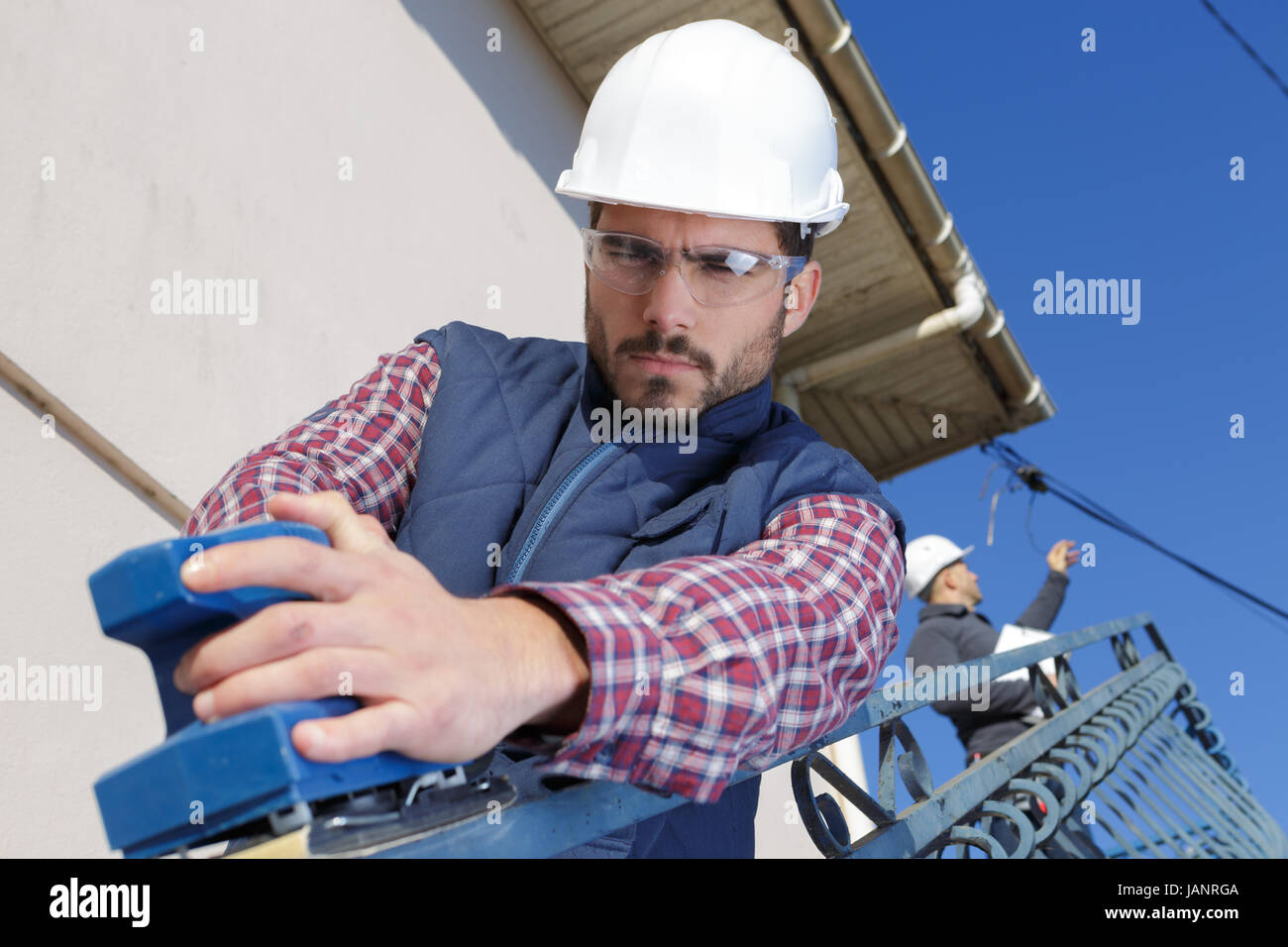 worker operating a sky lift to do maintenance work outdoor Stock Photo ...