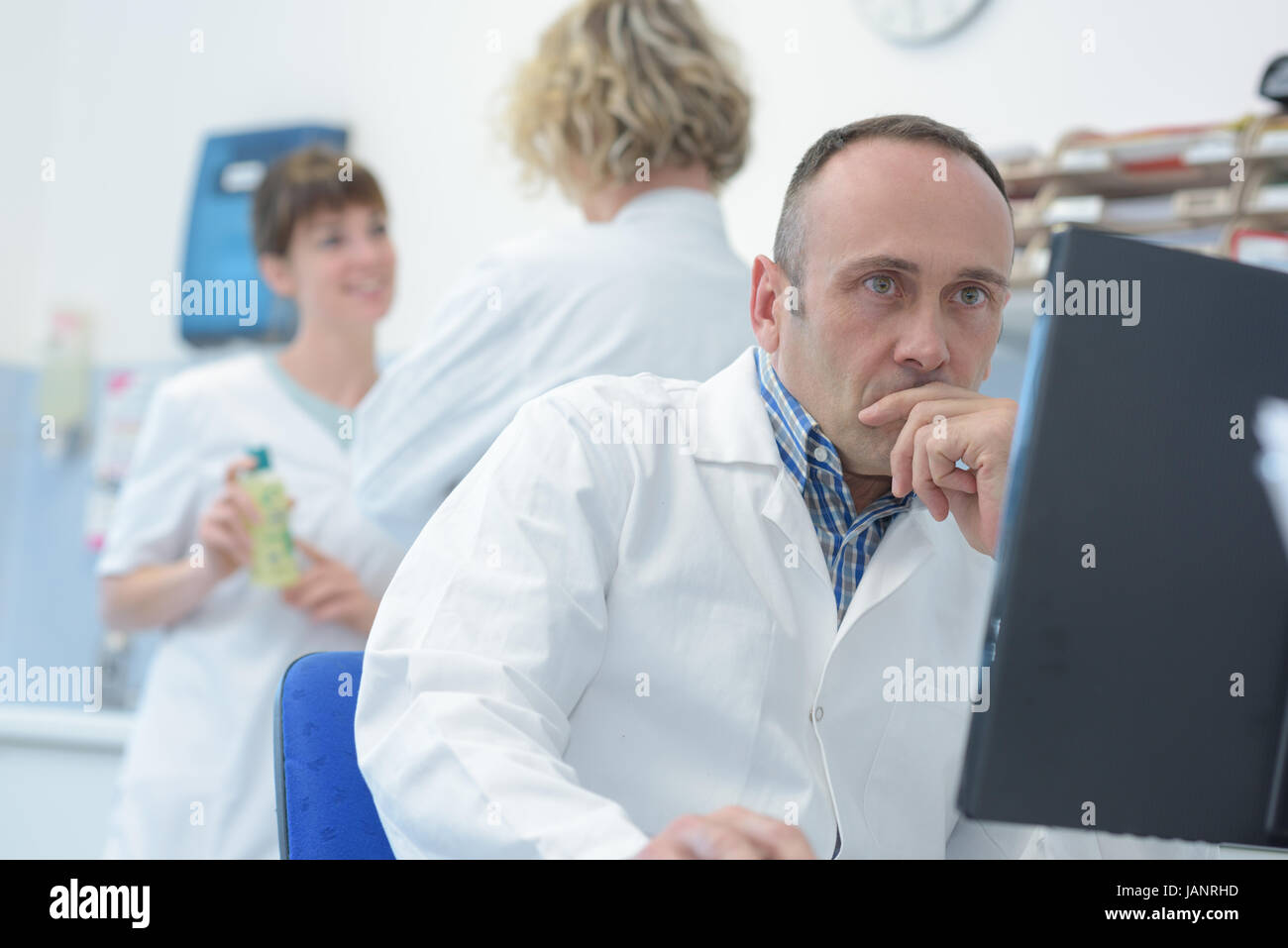 doctor looking at computer screen Stock Photo - Alamy