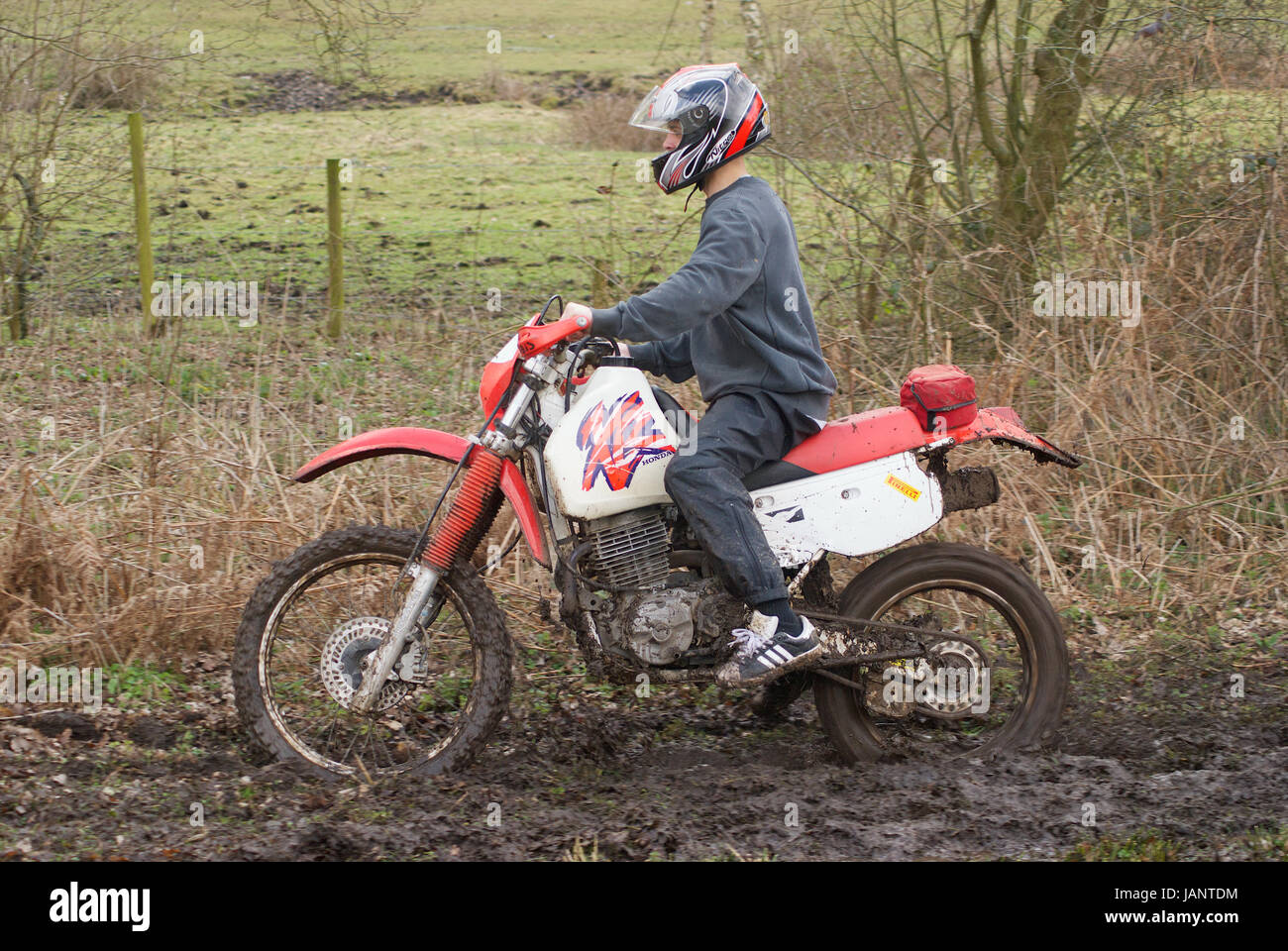 Riding a Honda 600XR motorcycel off-road in the mud Stock Photo - Alamy