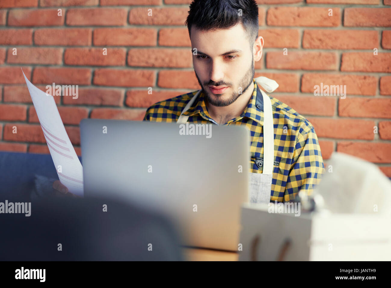 Focus waiter working with laptop in the bar Stock Photo - Alamy