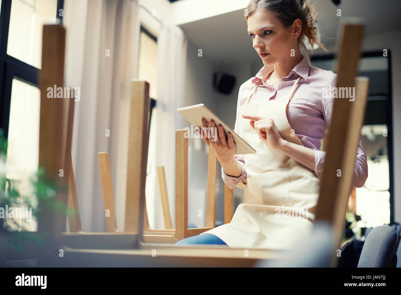 Confident waitress doing checklist in restaurant Stock Photo - Alamy