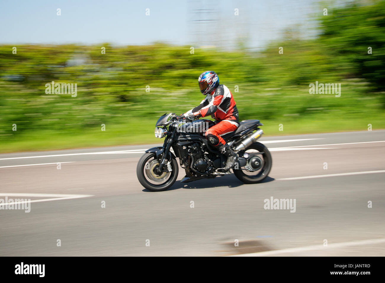Rider on a Triumph Street Triple motorcycle with motion blur Stock ...