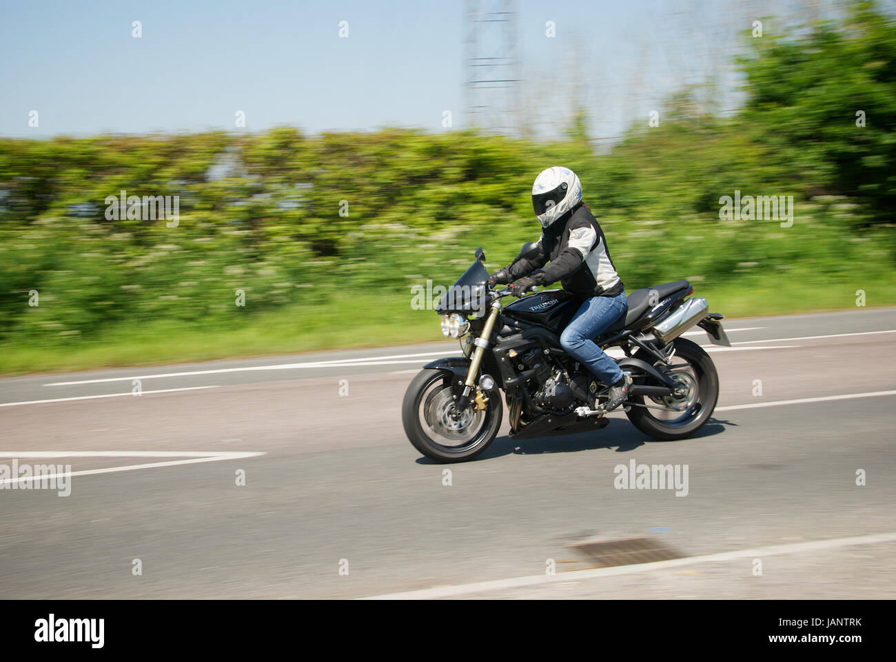 Rider on a Triumph Street Triple motorcycle with motion blur Stock ...