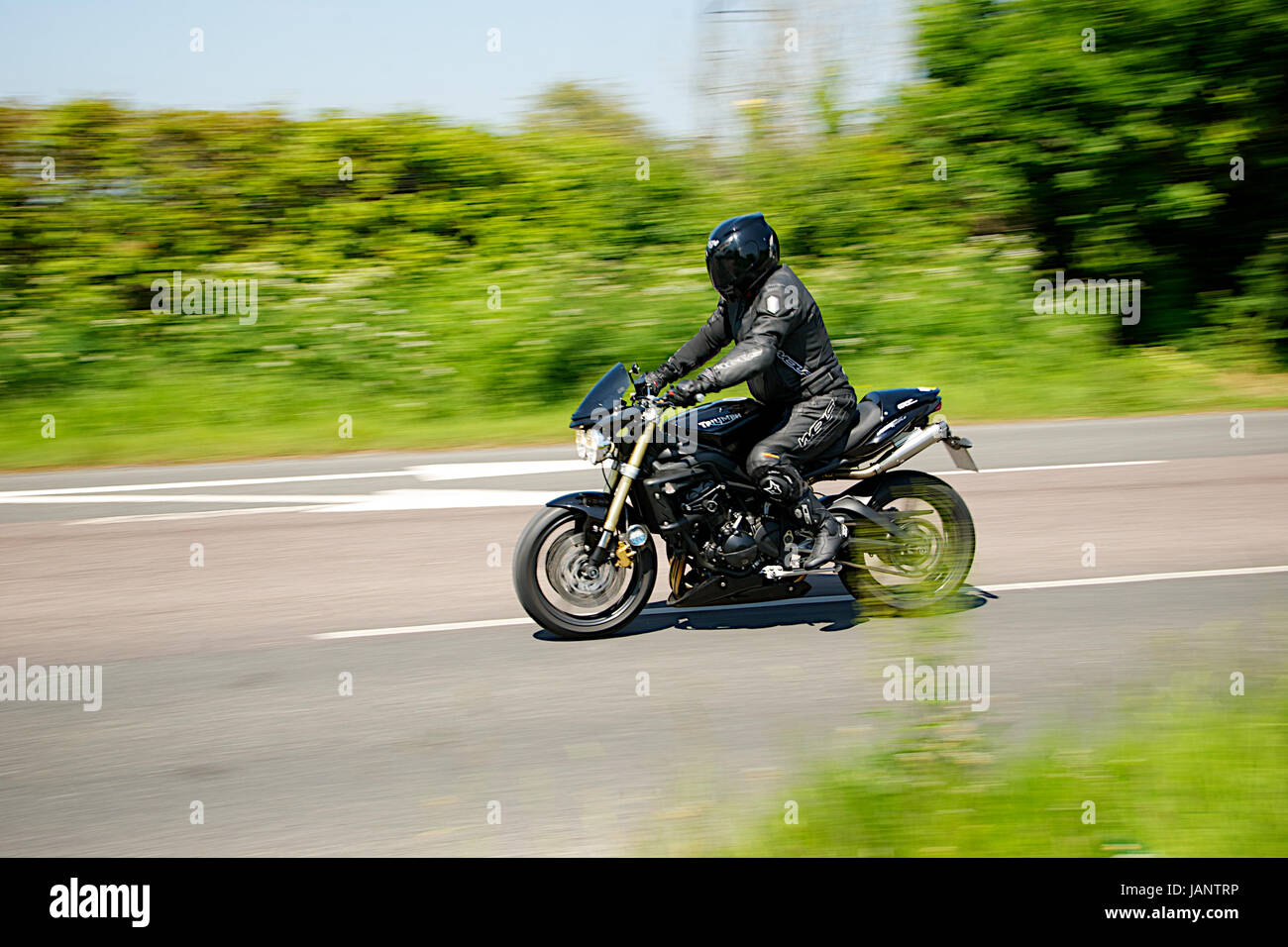 Rider on a Triumph Street Triple motorcycle with motion blur Stock ...