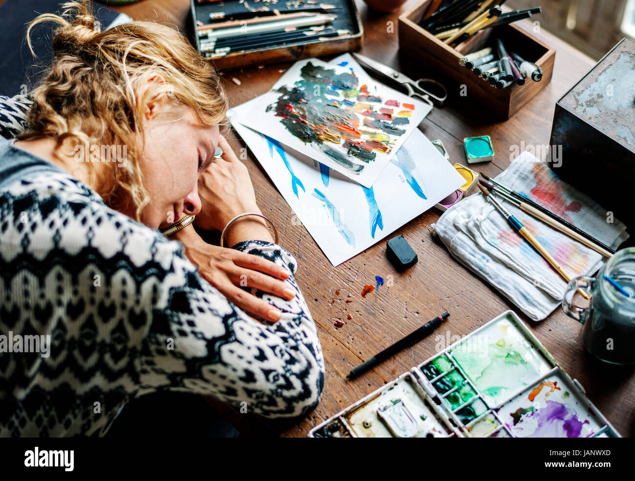 Closeup of artist woman taking a nap on work table Stock Photo - Alamy