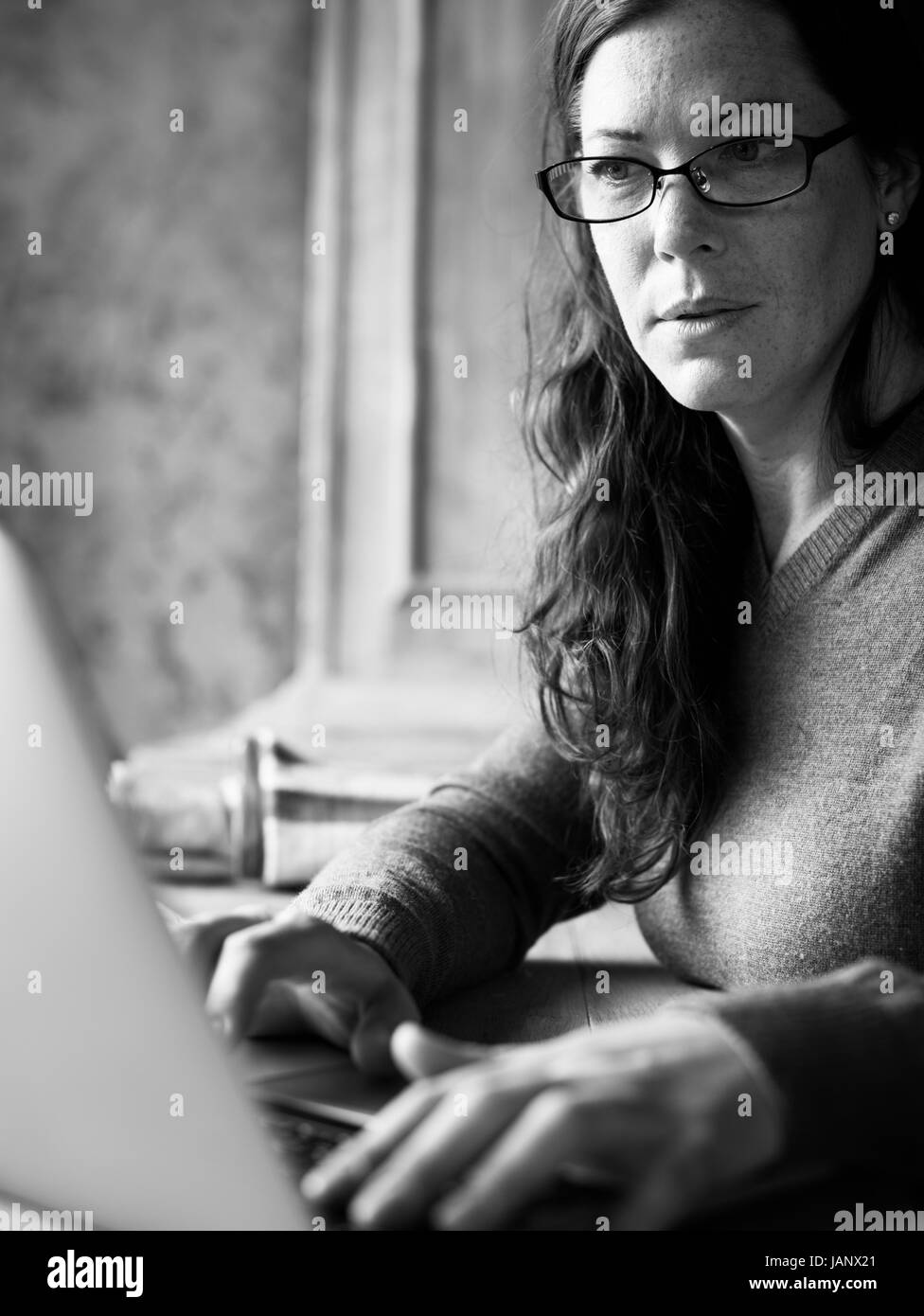 Caucasian woman using computer laptop grayscale Stock Photo - Alamy