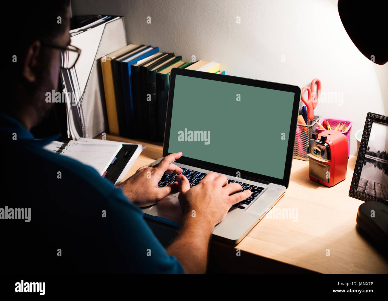 Rear view of brazillian man sitting working on computer laptop Stock ...