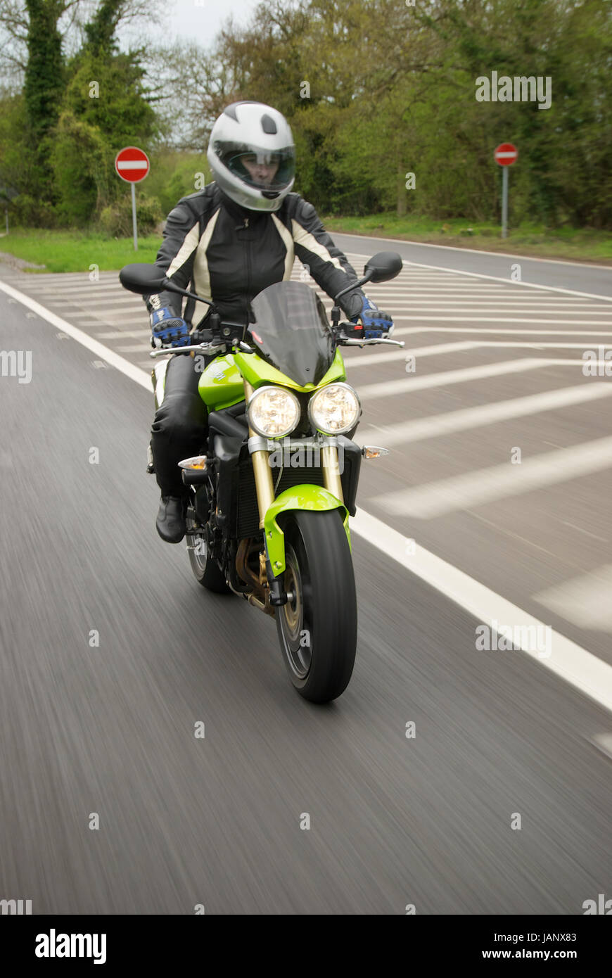 Motorcycle rider on the road at speed on a Triumph Street Triple ...