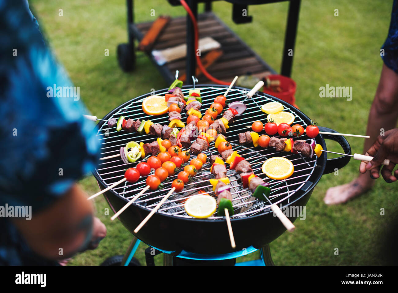 Group of diverse friends grilling barbecue outdoors Stock Photo - Alamy