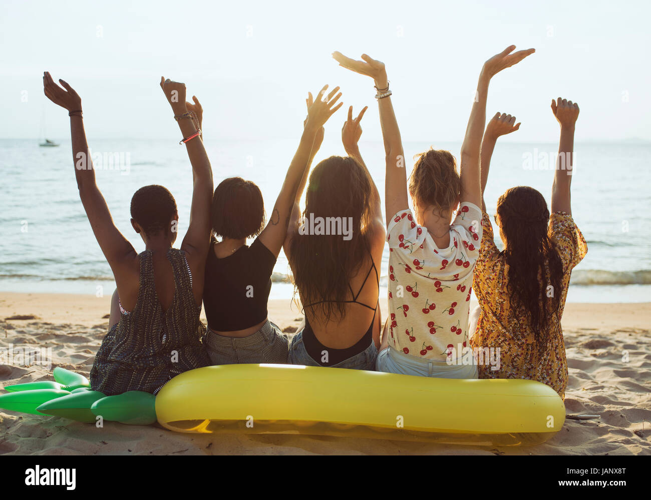 Group of diverse women sitting at the beach together Stock Photo - Alamy