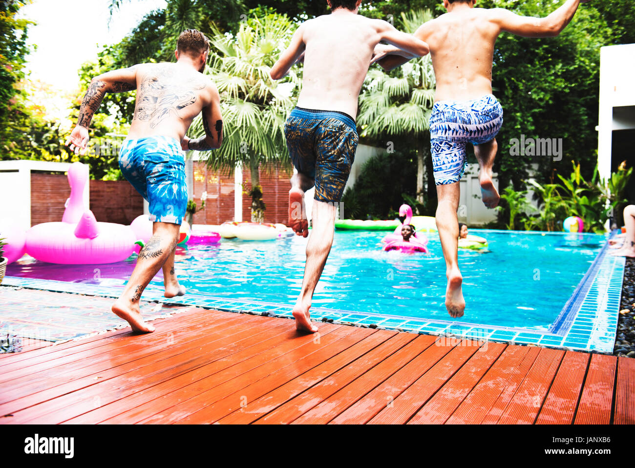 Group of diverse men jumping to the pool Stock Photo - Alamy