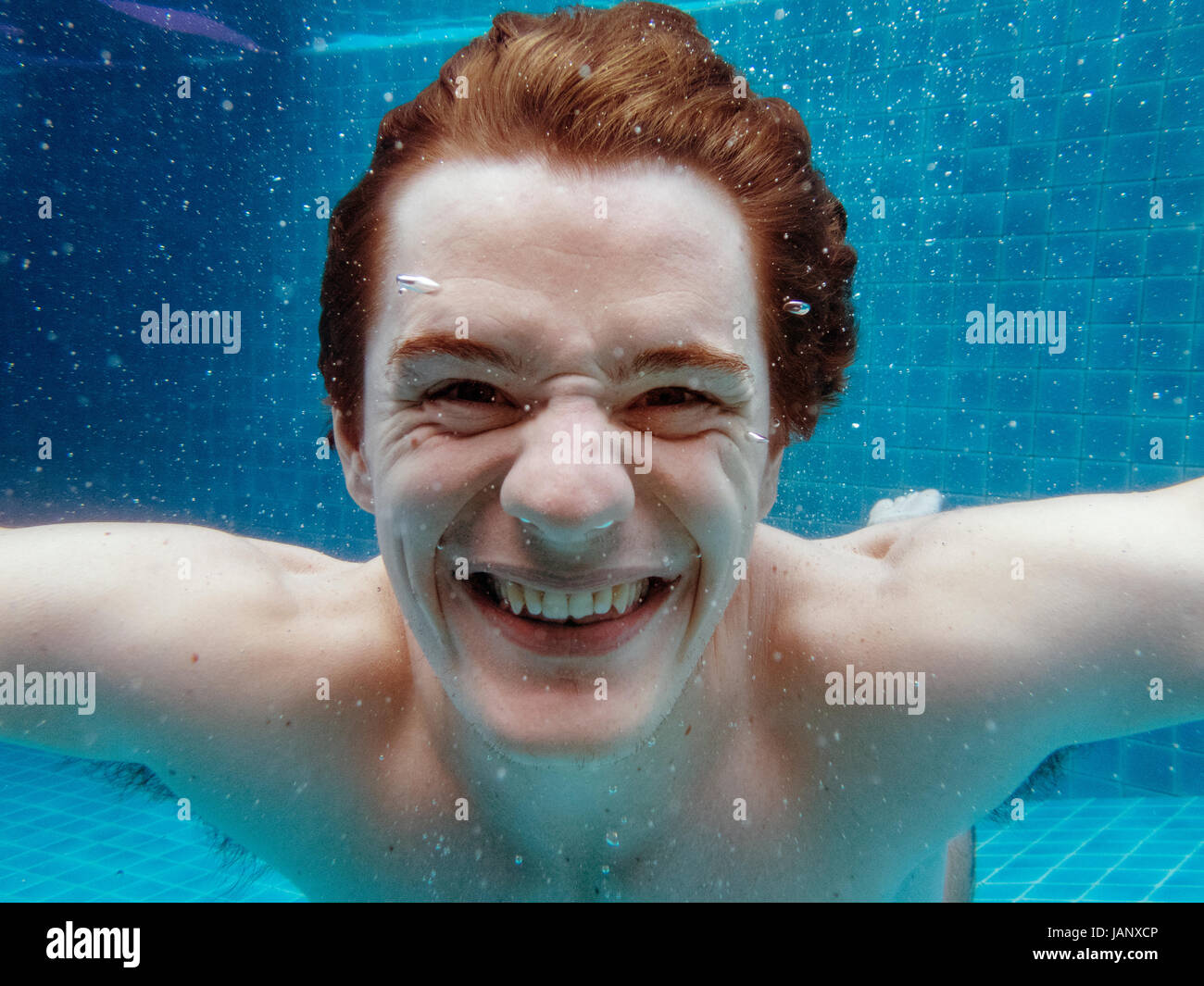 Caucasian man smiling underwater in swimming pool Stock Photo - Alamy