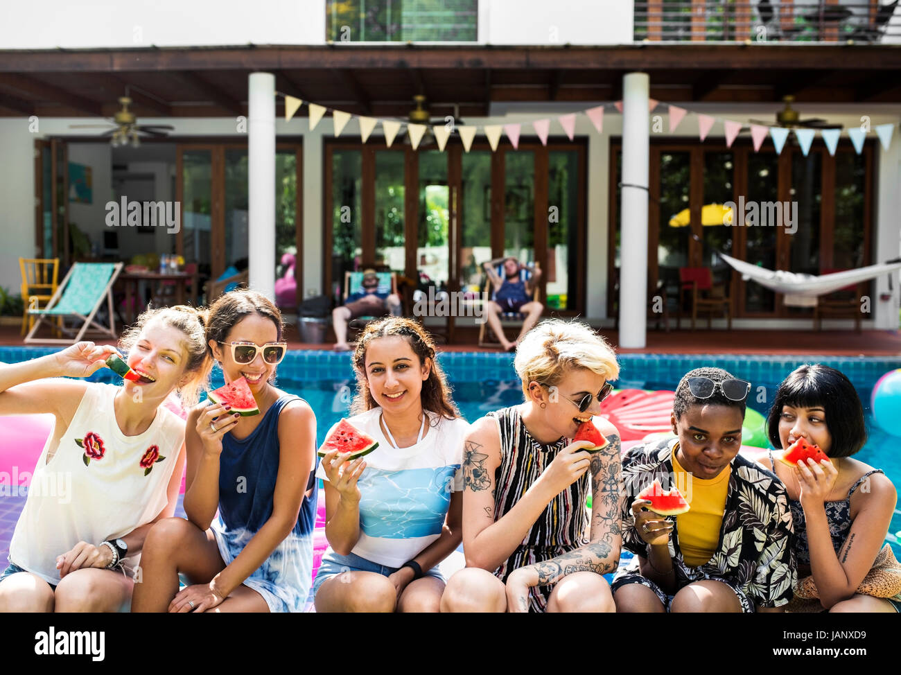 Group of diverse women sitting by the pool Stock Photo - Alamy