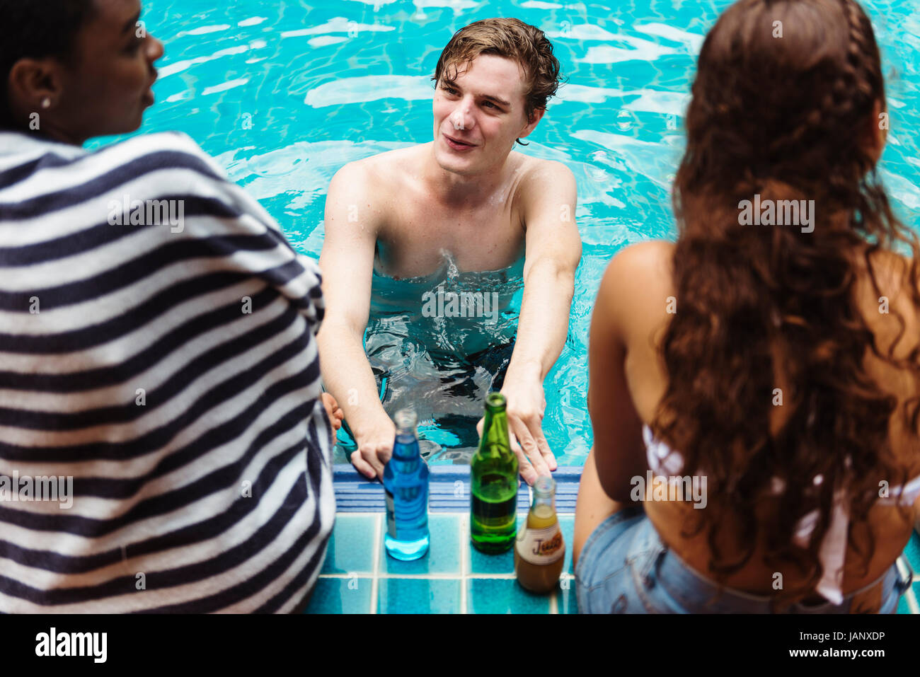 Group of diverse friends enjoying summer time by the pool Stock Photo ...
