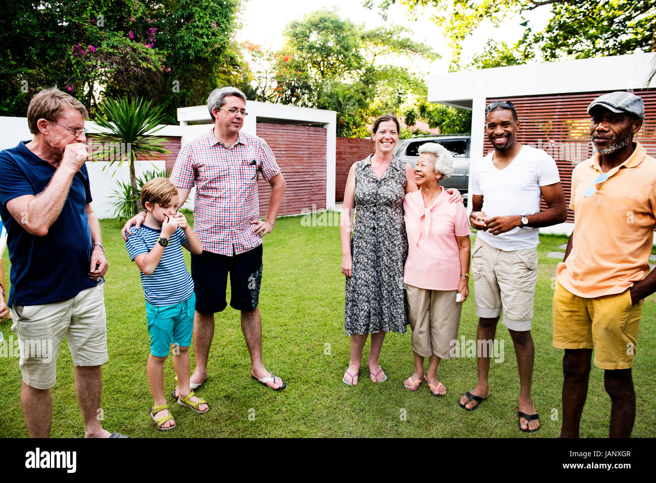 Group of diverse people standing at the backyard together Stock Photo ...