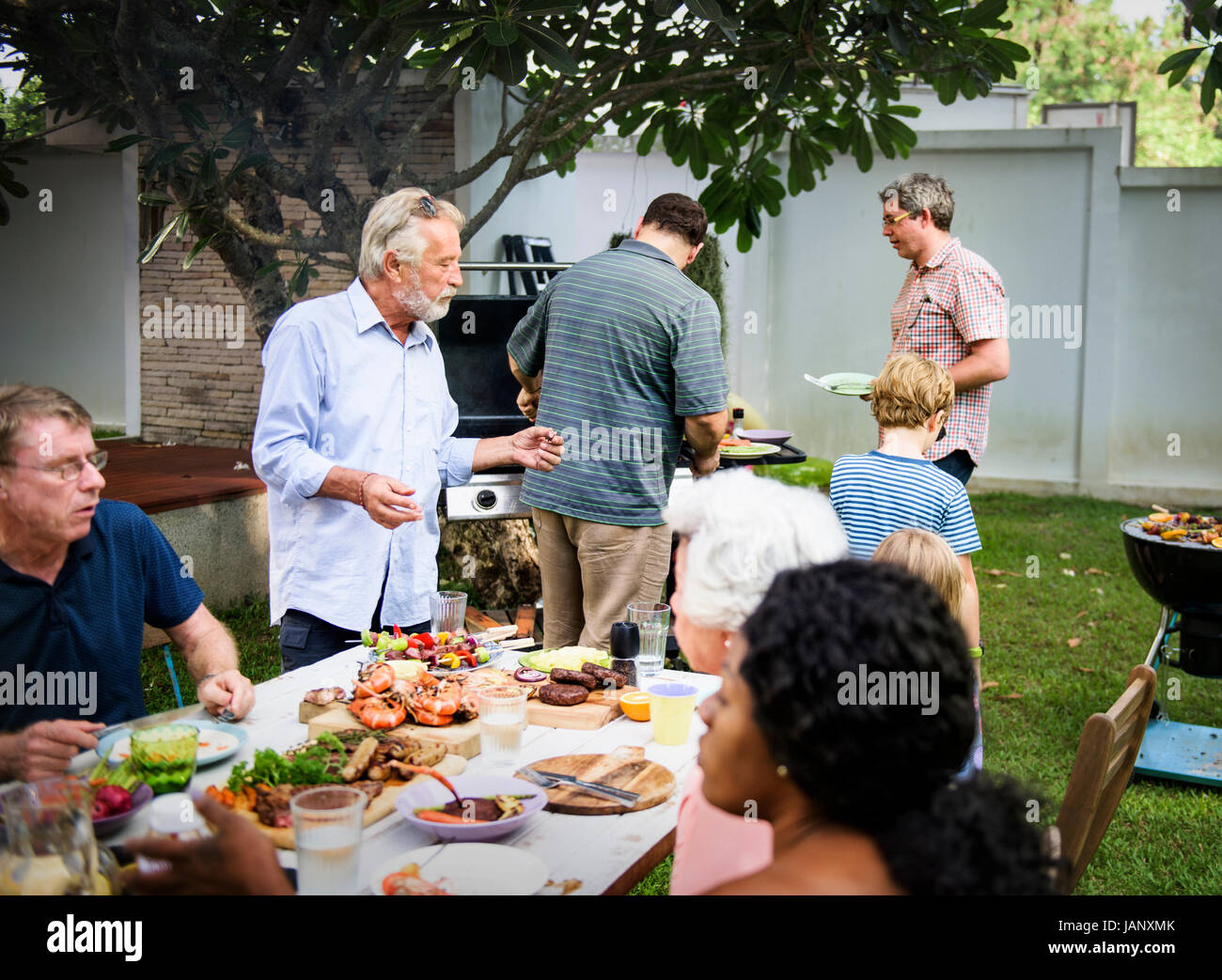 Group of diverse people enjoying barbecue party together Stock Photo ...