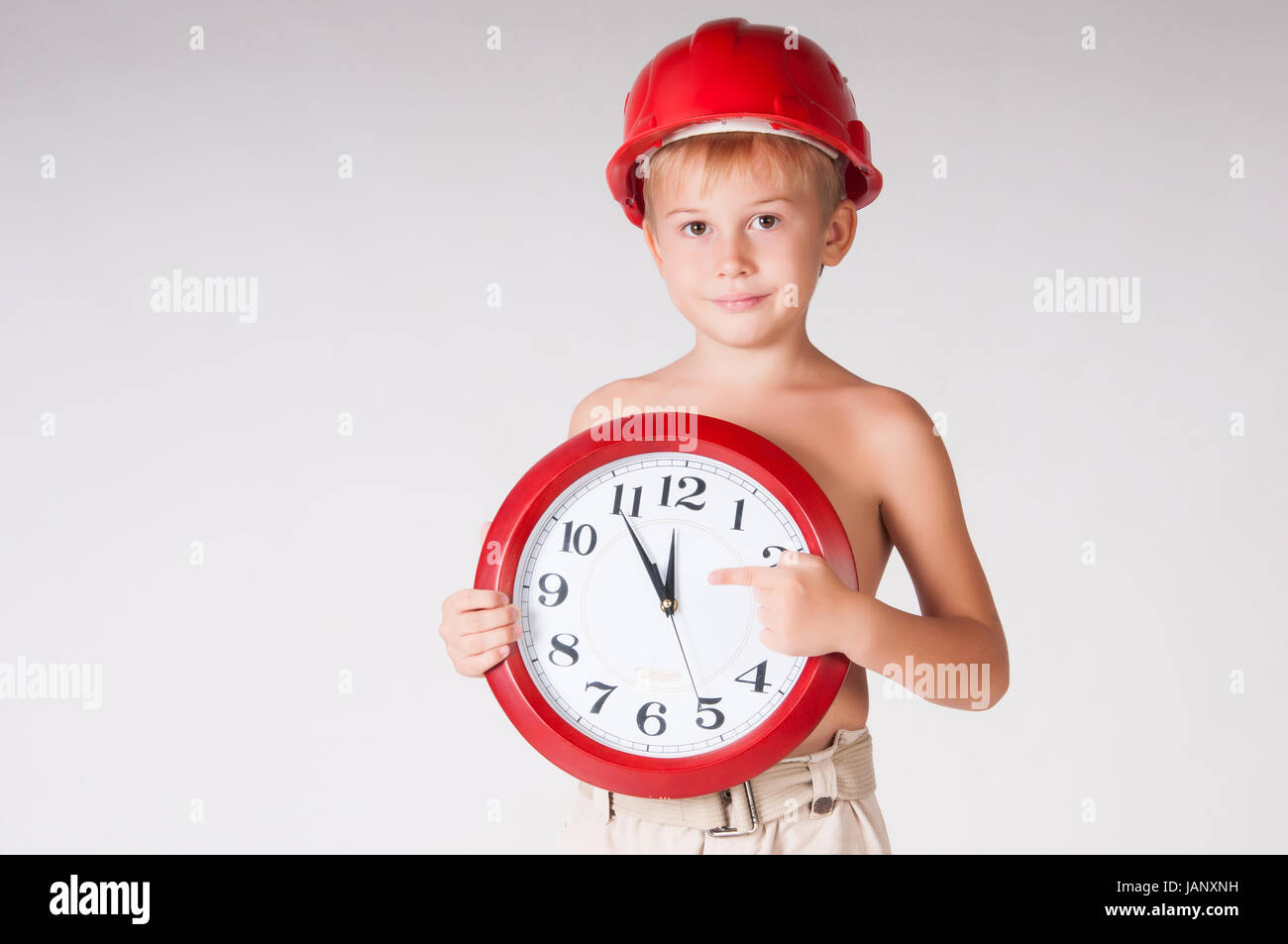 Boy builder in helmet with clock. White background Stock Photo - Alamy