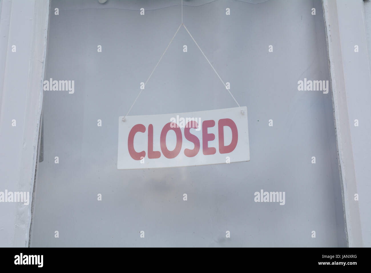 Closed sign in shop door window Stock Photo - Alamy