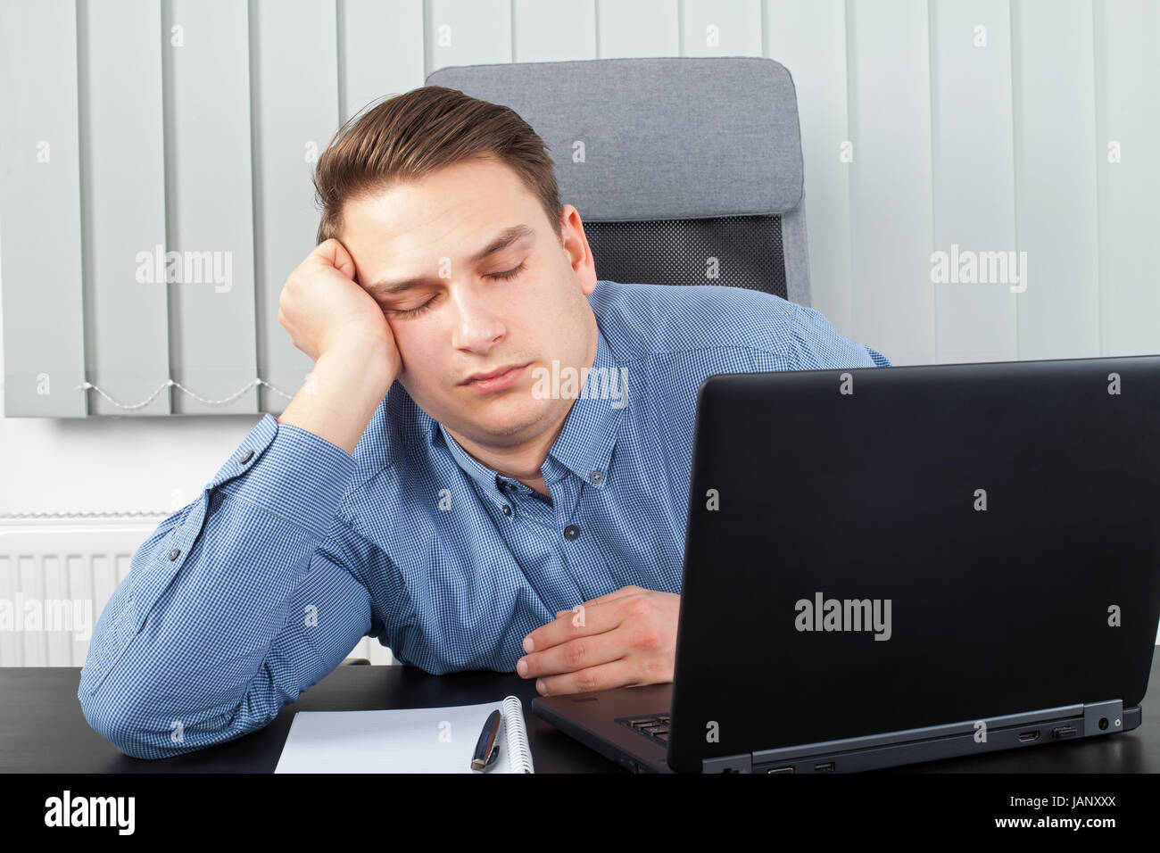 Picture of an exhausted young businessman at the office Stock Photo - Alamy